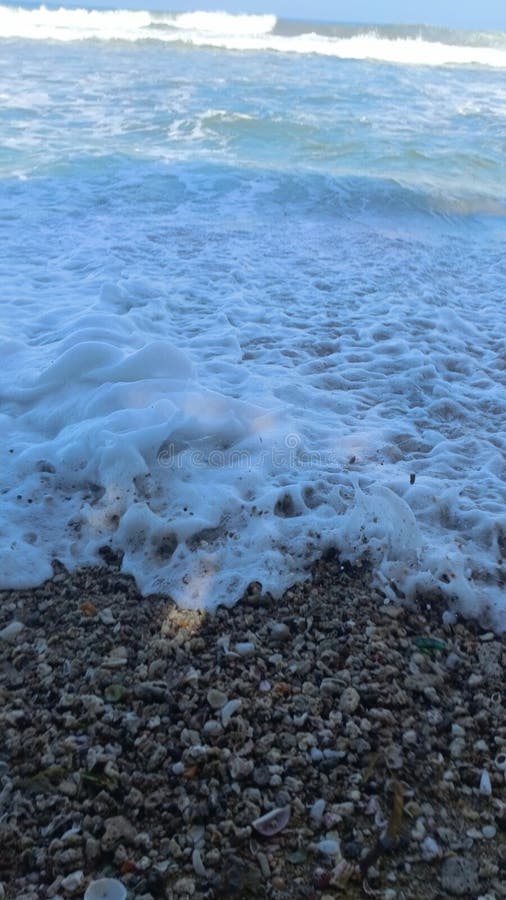 Waves Washing Over Pebble Beach Stock Photo - Image of beach, covered ...