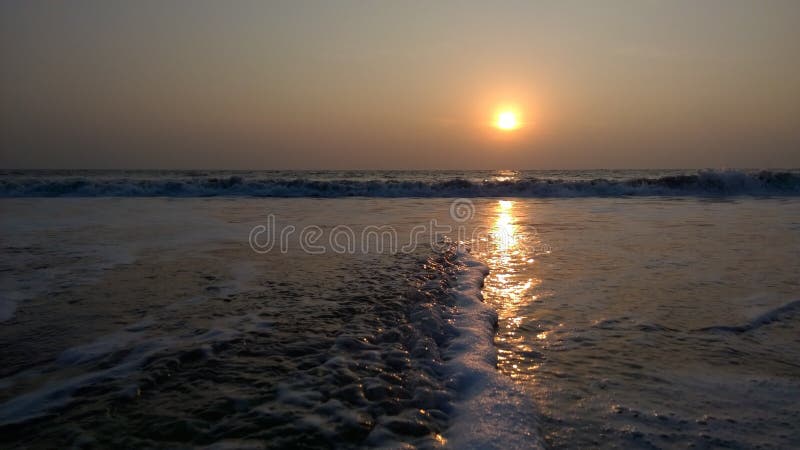 Waves in the Water with the Sun Going Down Over the Horizon Stock Photo - Image of golden, ocean ...