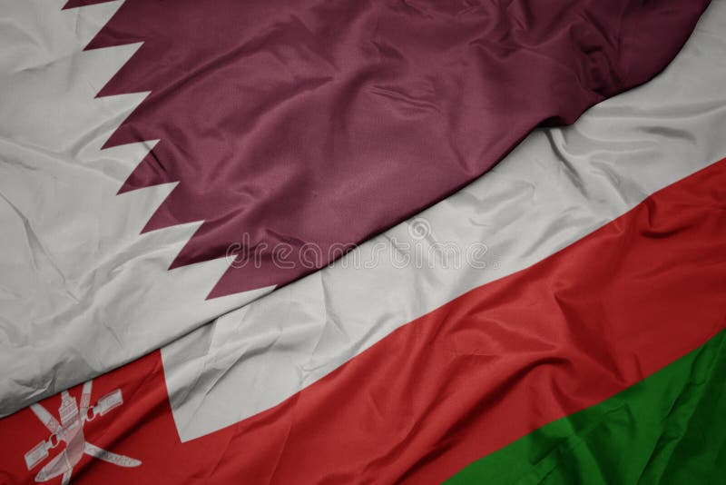 Waving Colorful Flag of Oman and National Flag of Qatar Stock Photo ...