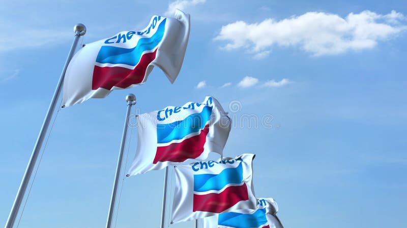 Waving Flags with Chevron Logo Against Sky, Editorial 3D Rendering ... Waving Flags with Chevron Logo Against Sky, Editorial 3D Rendering ...