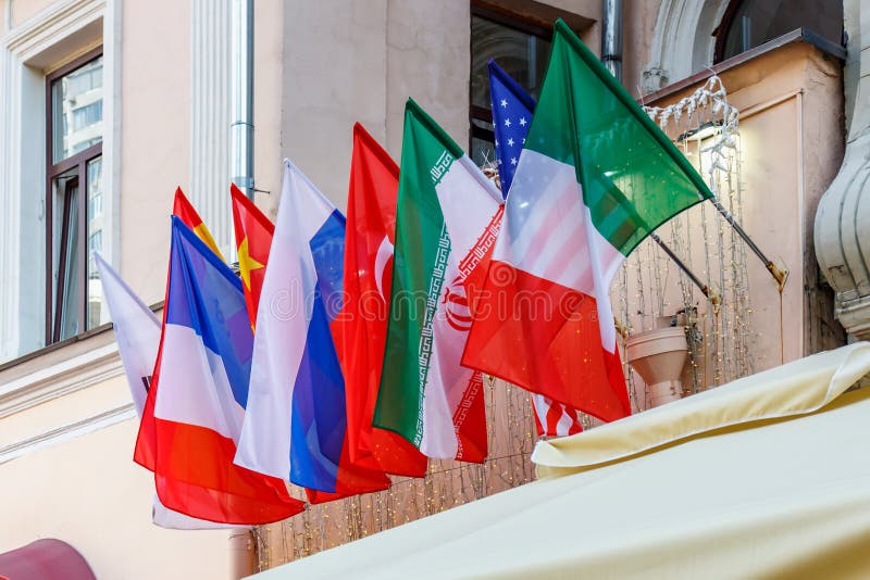 Waving Flags of Different Countries in a Row on the Wall in Sunlight ...