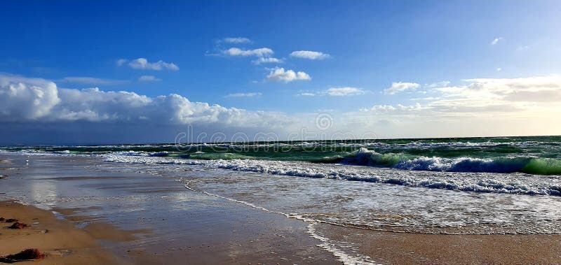 Wavy Beach Captured during the Daytime with Clouds in the Sky Stock ...