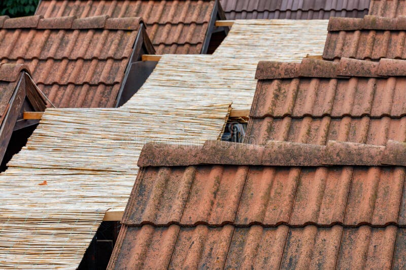 Wavy Old Sloping Roofs Made of Clay Tile and Thatch Stock Image - Image ...