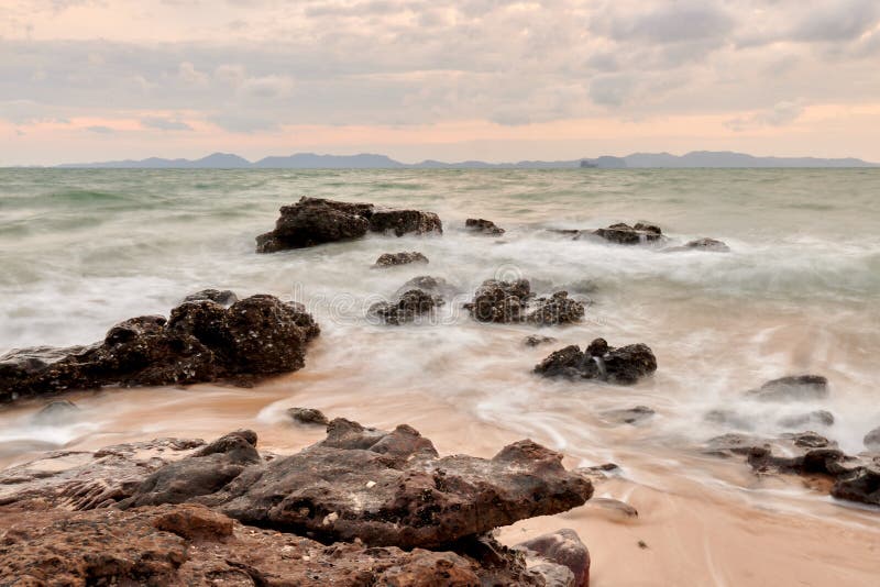 Wavy Sea with Rocks Near a Beach Stock Photo - Image of coastline ...