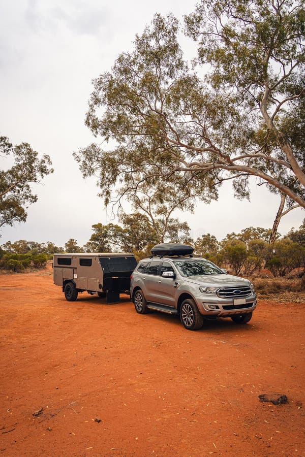 Off-road Vehicle Towing a Camper through the Australian Outback. Stock ...