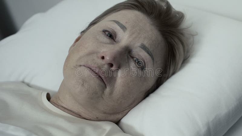 Weak Crying Lady Lying in Bed and Looking at Camera, Hospice Center ...
