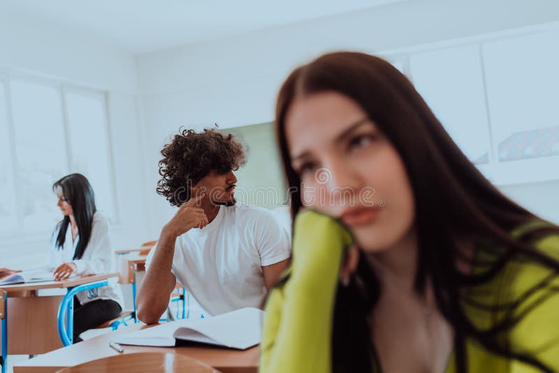A Weary-looking Student Sitting in Front of a Group of Diverse Students ...