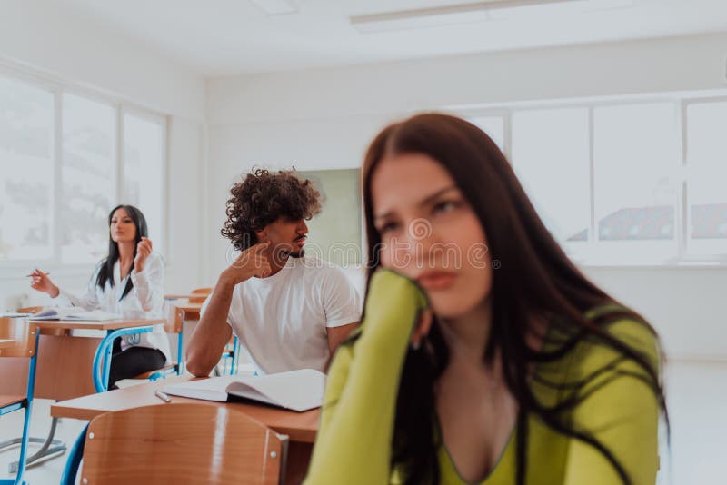 A Weary-looking Student Sitting in Front of a Group of Diverse Students ...