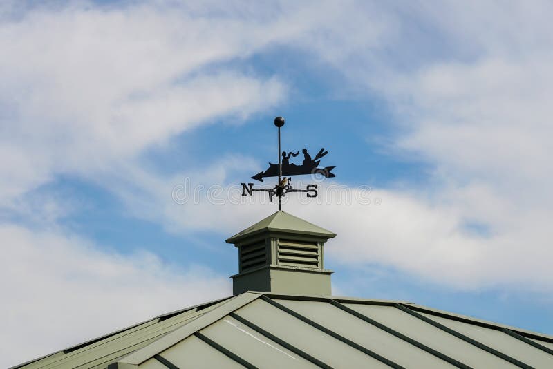 Weather Vane in the Form of a Canoe Against the Blue Sky. Stock Image ...