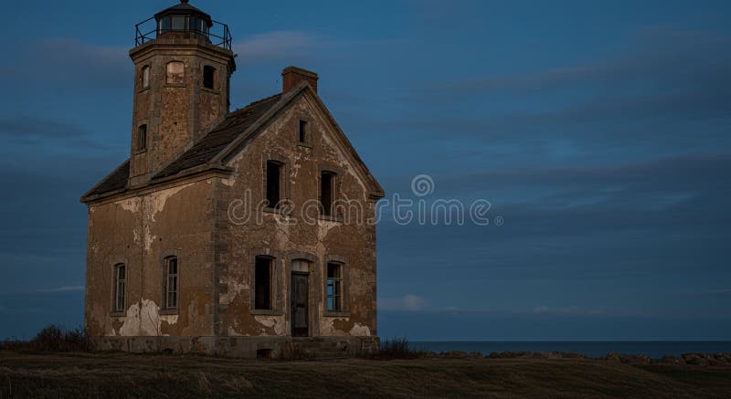 A Weathered, Abandoned Lighthouse Stands Against a Backdrop of an ...