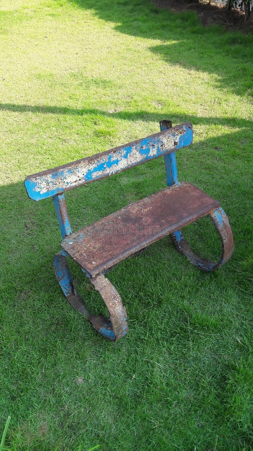 Weathered Bench Setting on Green Grass, Seating is Made of Rusted Metal ...