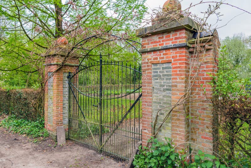Weathered Black Painted Iron Gate between Brick Pillars Stock Photo ...