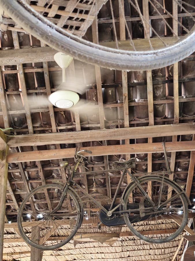 A Weathered Black Vintage Bicycle Suspended from the Ceiling Adds a ...