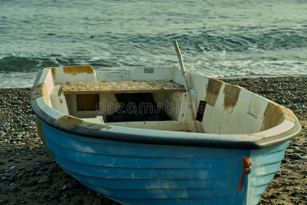 Weathered Blue Rowboat on a Pebbled Beach Stock Image - Image of blue ...