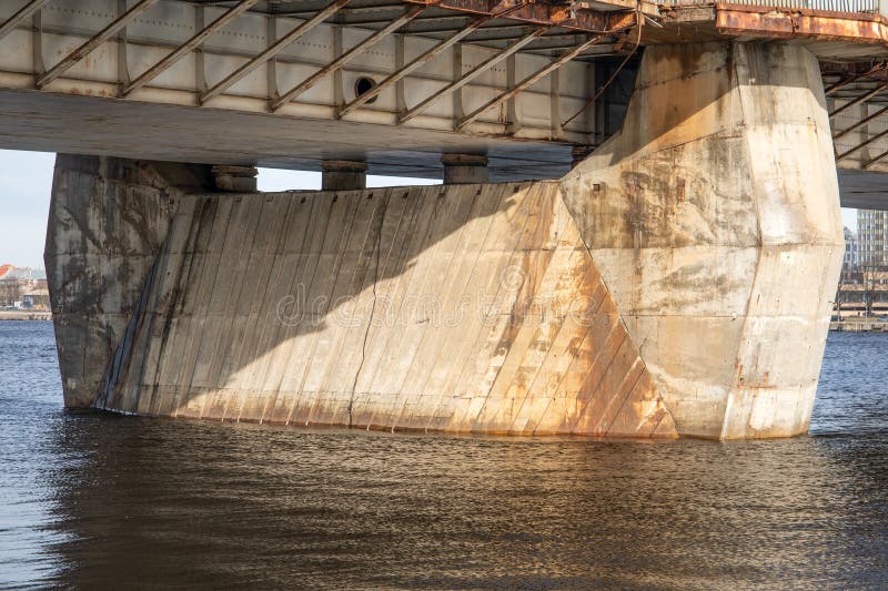Weathered Bridge Support Structure with Concrete Base and Rusty Metal ...