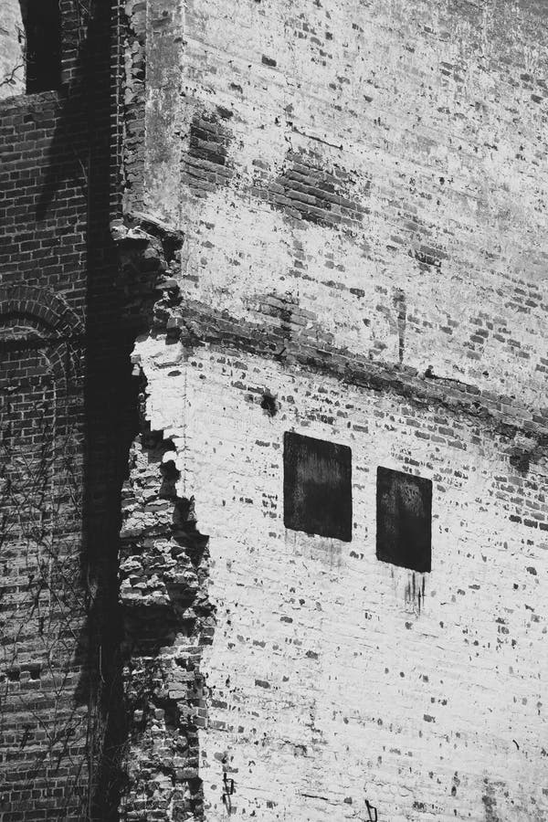 White Weathered Brick Wall of Abandoned Building with Two Black Squares ...