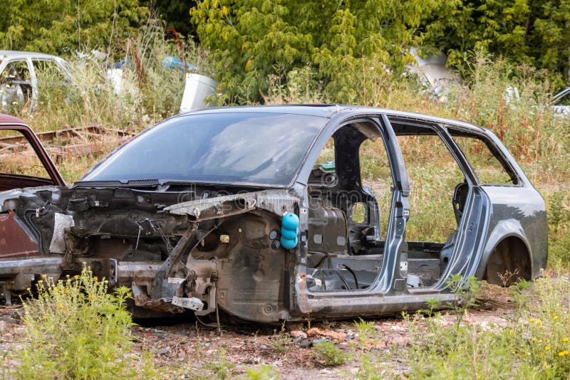 Weathered Car Body Parts Abandoned in Greenery Stock Photo - Image of ...