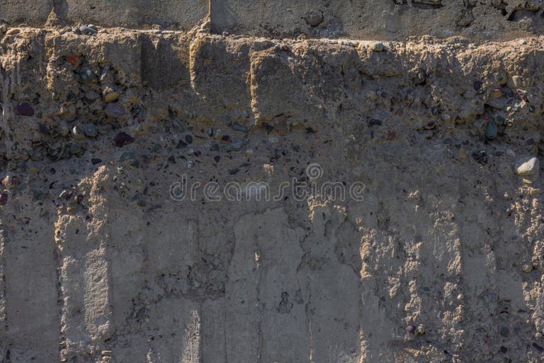 Weathered Cheap Uneven Concrete Surface with Pebbles Under Tangential ...