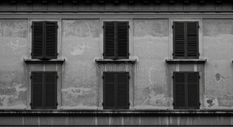 Weathered Gray Stone Building Facade with Closed Shutters Stock ...