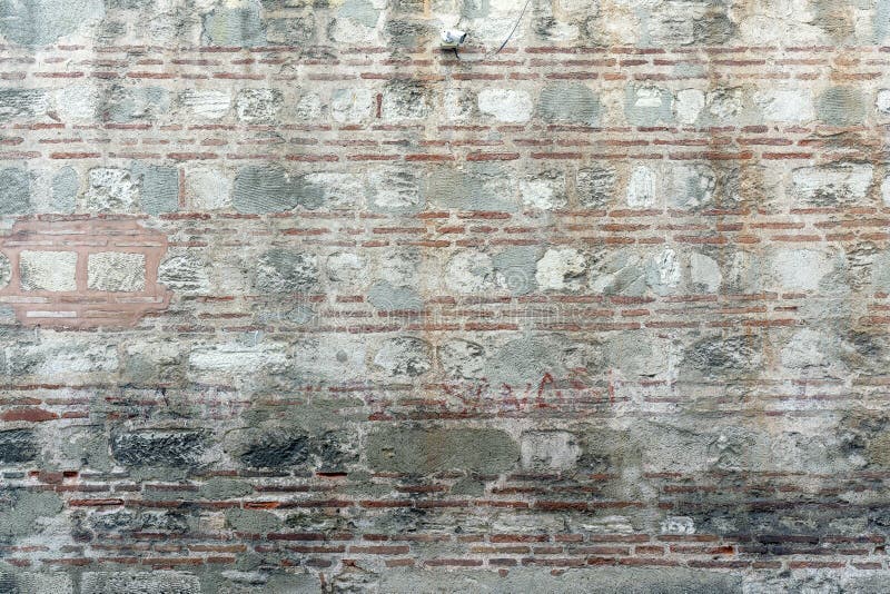 Alternating Rows of Bricks and Stones Form an Old Weathered Wall ...