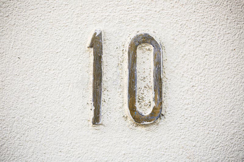 Weathered Metallic Number 10 Mounted on a Textured Cream Wall. Stock ...