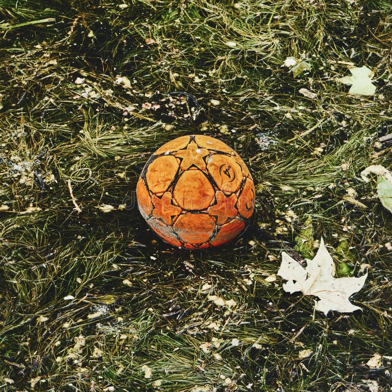 Weathered Orange Soccer Ball on the Grass Stock Photo - Image of soccer ...