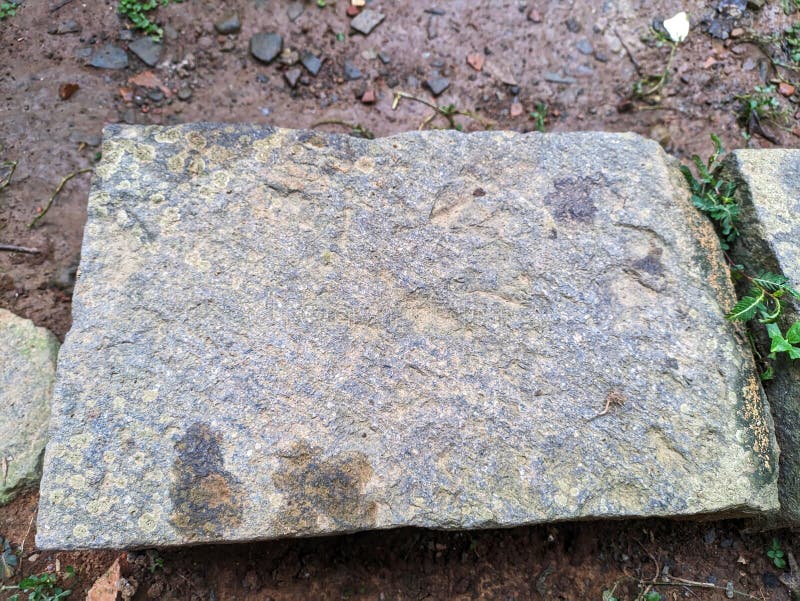 A Weathered Rectangular Stone Slab with a Rough Surface and Patches of ...
