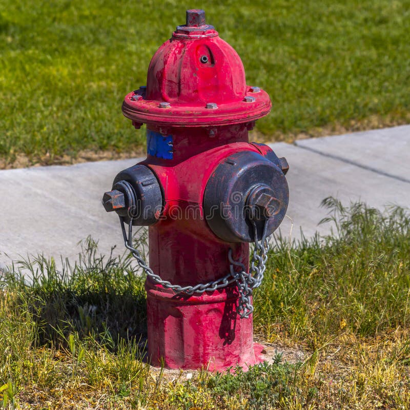 Weathered Red Fire Hydrant on a Grassy Ground Stock Photo - Image of ...