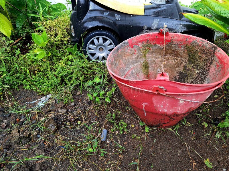 Weathered Red Pail and Toy Car in Rainy Backyard Stock Photo - Image of ...
