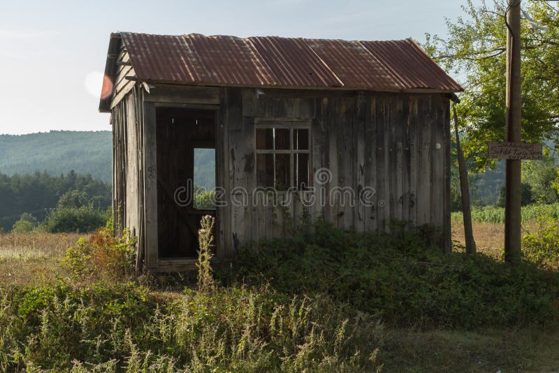 Old Weathered Shack with Dirty Windows and Cloth Curtains on Sunny Day ...