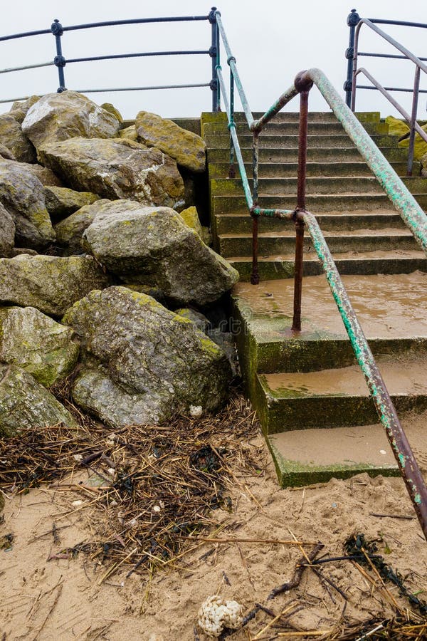 Weathered Stone Steps from Sand-covered Beach, Bordered by Mossy Rocks ...