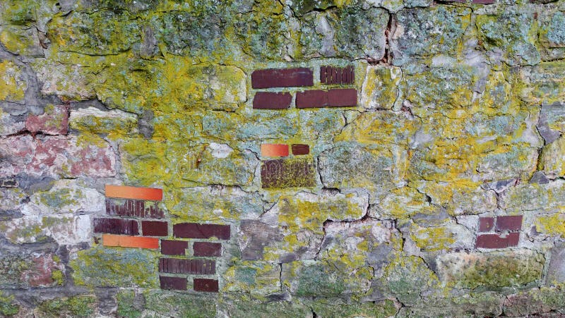 A Weathered Stone Wall Covered in Moss and Bricks in a Rustic Setting ...