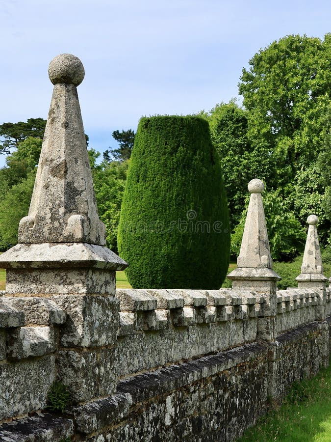Topiary Bush and Old Weathered Stone Wall at Lanhydrock in Cornwall ...