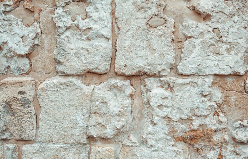 Weathered Stone Wall with Rough Texture and Sandy Tones Stock Image ...