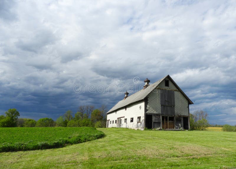 Weathered Old White FingerLakes Barn with Storm Approaching Stock Image ...