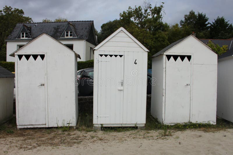 Weathered white beach huts stock image. Image of outdoors - 59232721