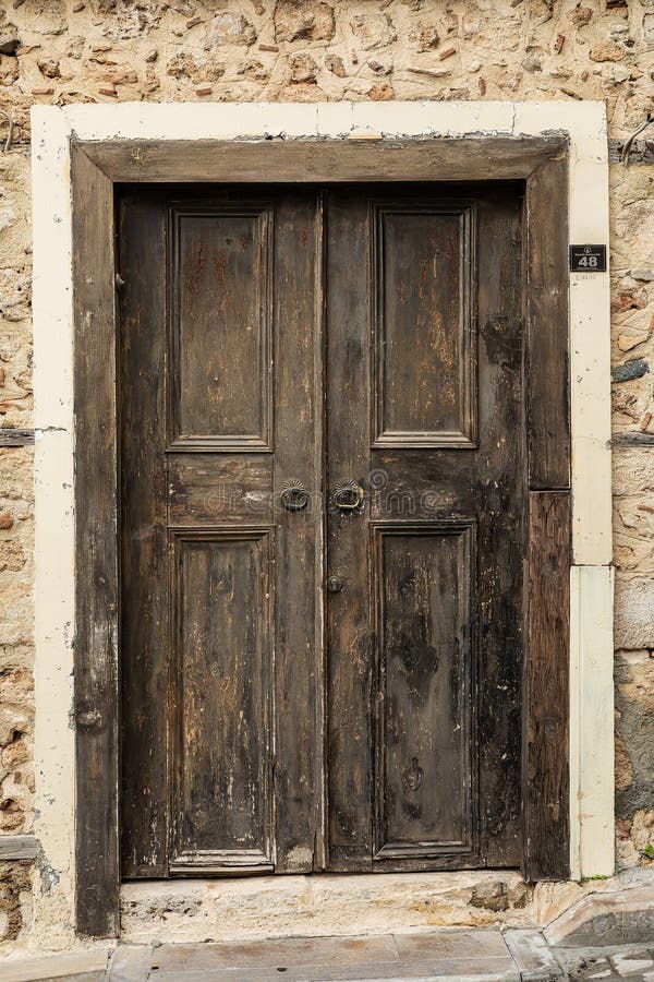 Weathered Wooden Door in Rustic Stone Wall Stock Image - Image of ...
