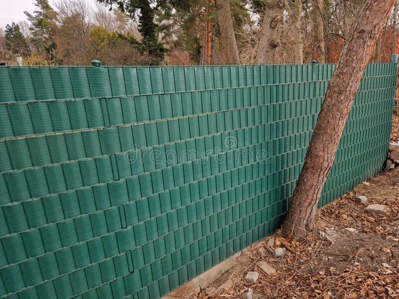 Weaving Plastic Strips through the Mesh of the Wire Fence. Protection ...