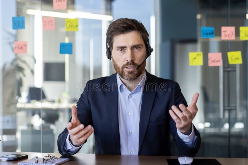 Web Camera View, Man with Headset Phone Inside Office Talking Seriously ...