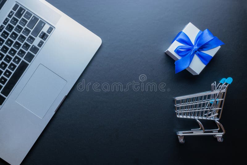Web Shopping. Laptop Computer, Shopping Trolley and White Gift with ...