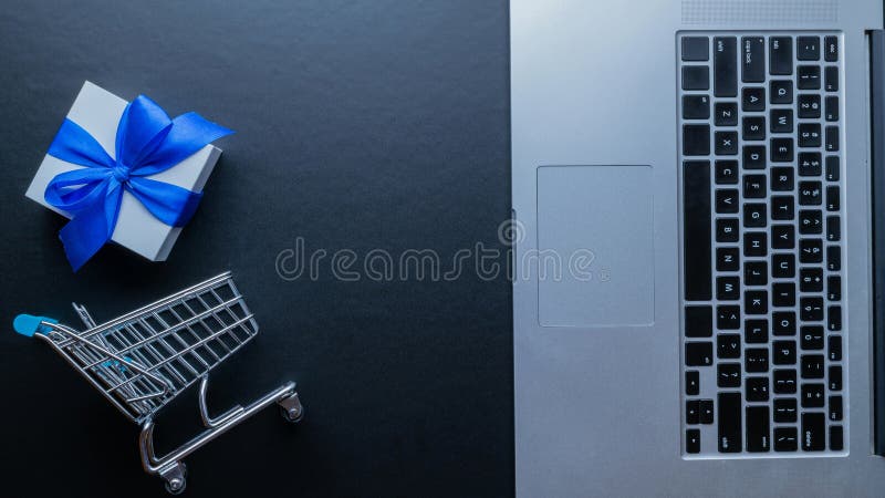 Web Shopping. Laptop Computer, Shopping Trolley and White Gift with ...