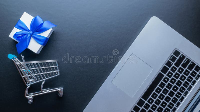 Web Shopping. Laptop Computer, Shopping Trolley and White Gift with ...