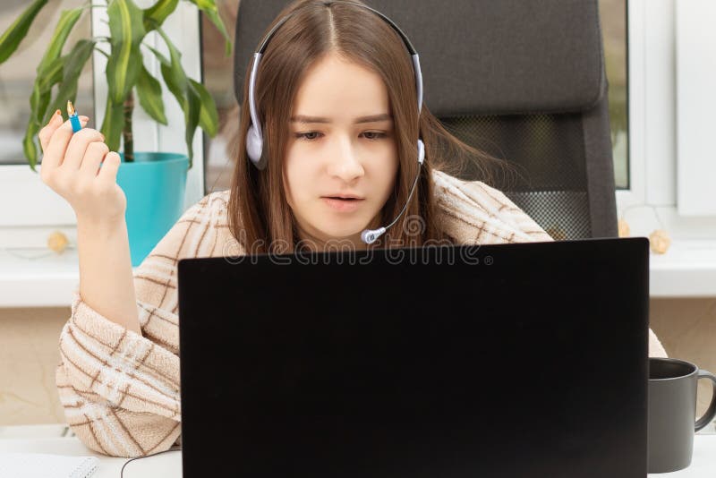 Webinar Online. a Student at Home is Studying with Headphones with a ...