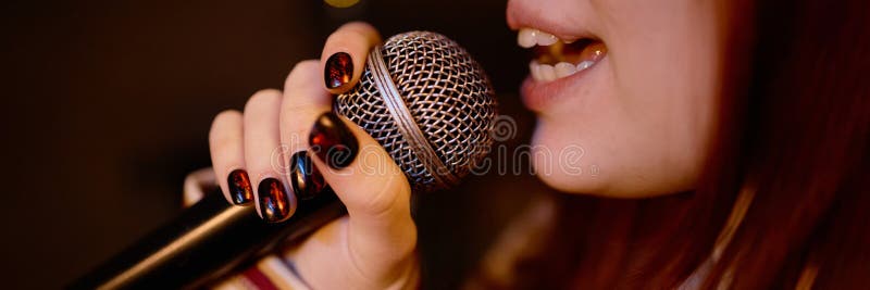 Header Image of Microphone in Hands of Young Female Vocalist Performing ...