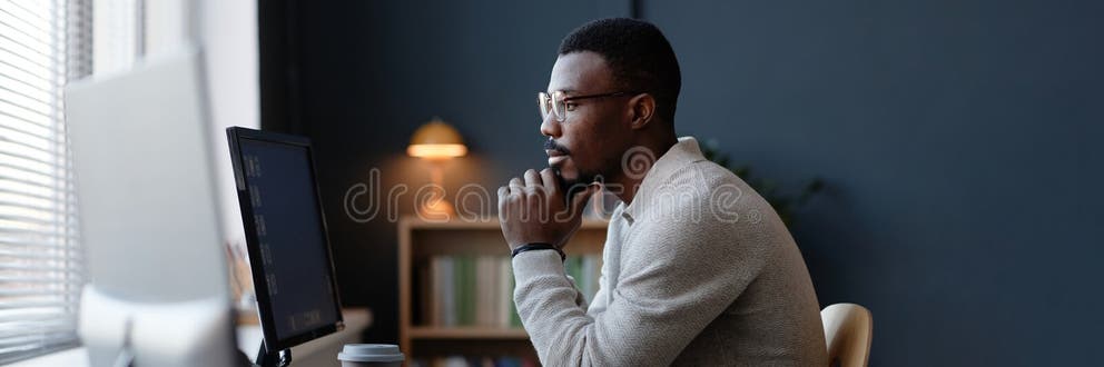 Header Image of Black Man Using Computer while Working at Desk in Home ...