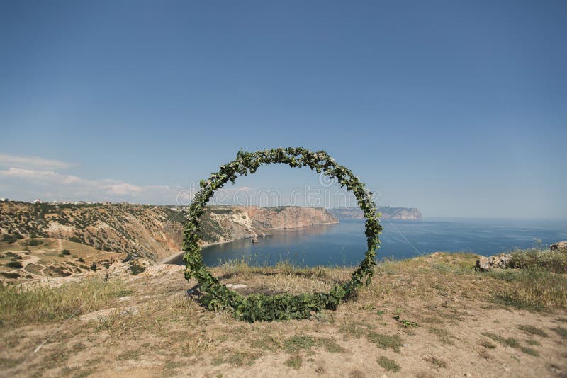 Wedding Arch in the Form of a Ring on a Cliff on the Background of the ...