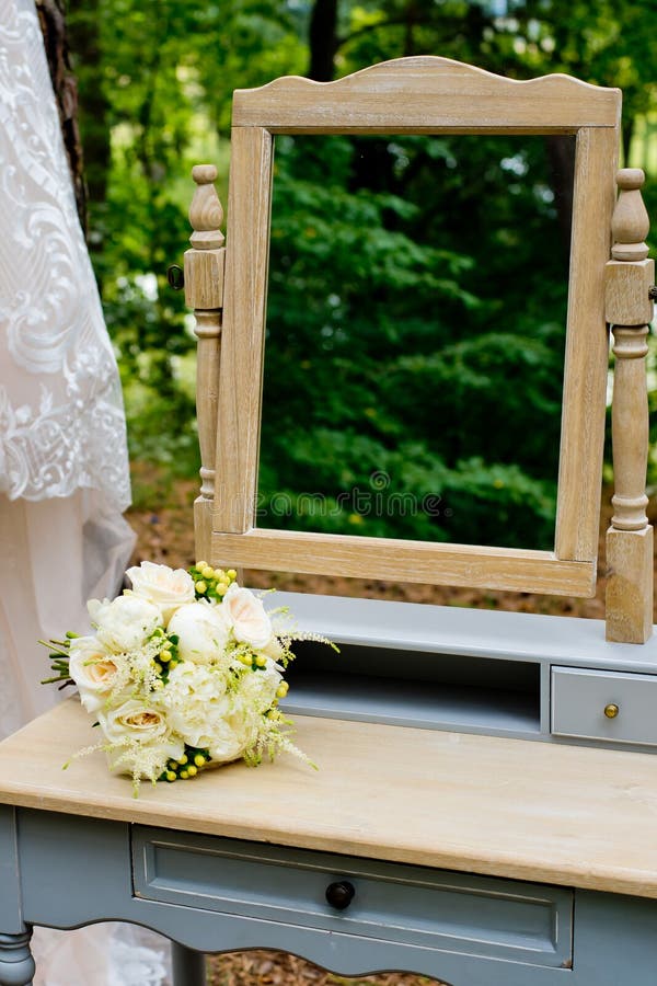 A Wedding Bouquet in the Forest on a Table with a Mirror. Stock Image ...
