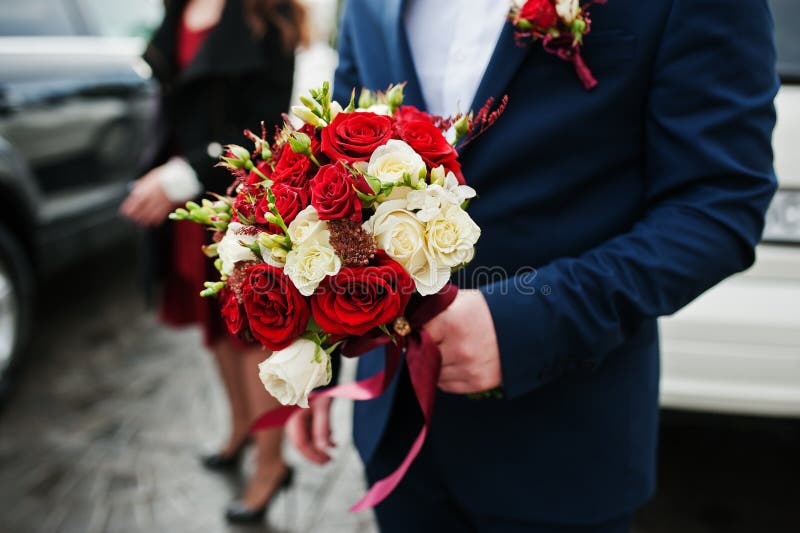 Wedding Bouquet of White and Red Roses on Hand of Groom. Stock Image ...