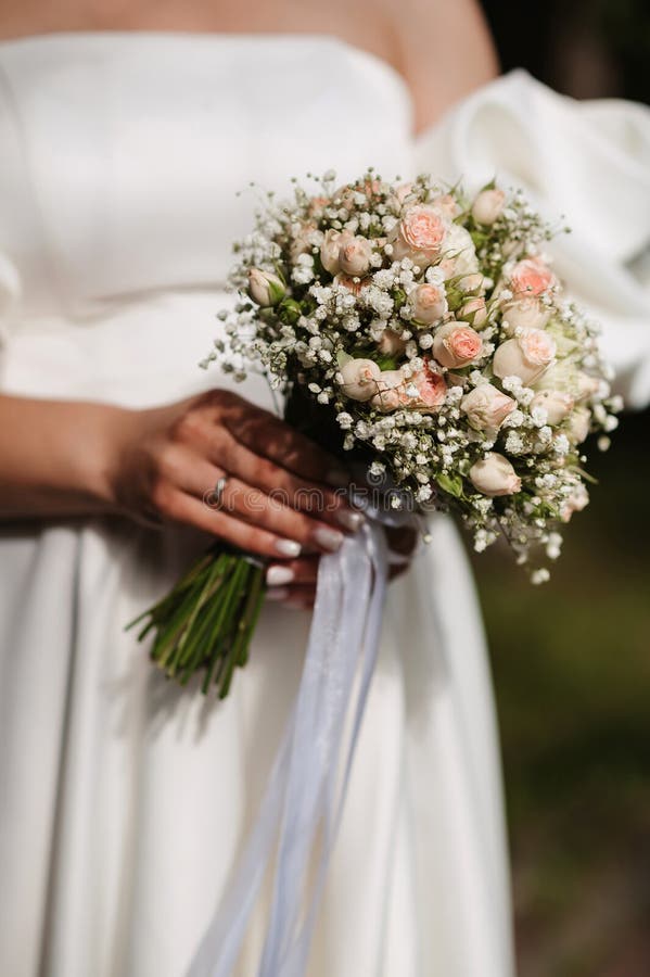 Wedding Bouquet of White Roses in the Hands of the Bride Stock Image ...