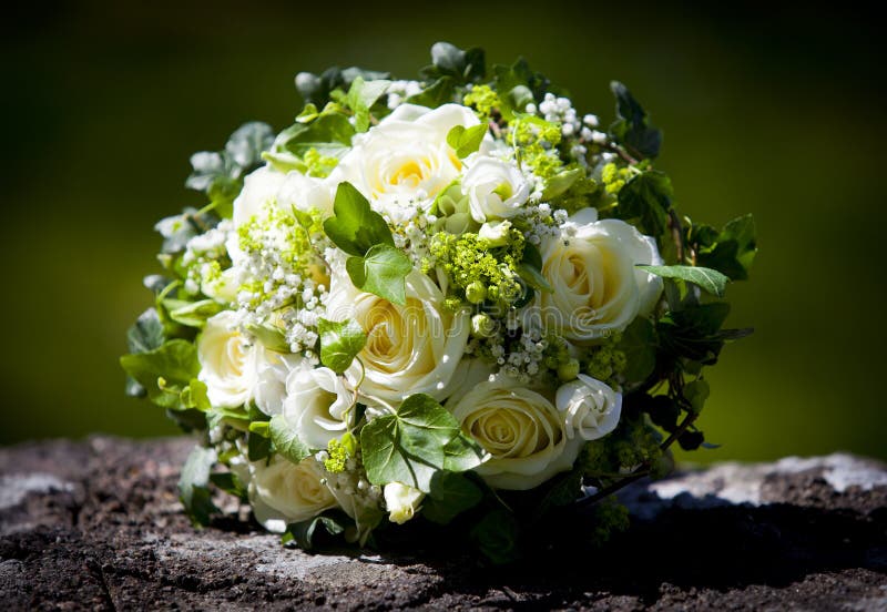 Wedding Bouquet with Yellow Roses Laying on a Limestone Wall Stock ...